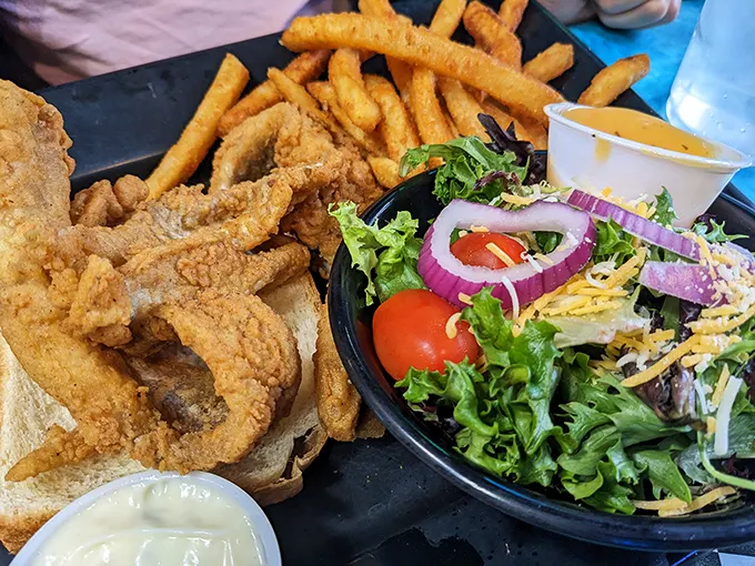 The Walleye Sandwich pays homage to freshwater fishing traditions with perfectly crispy fish that extends beyond its bun—a Midwestern portion if there ever was one.