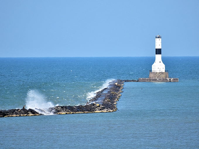 The West Breakwater Lighthouse stands guard where waves crash dramatically against the rocks—maritime drama at its finest.