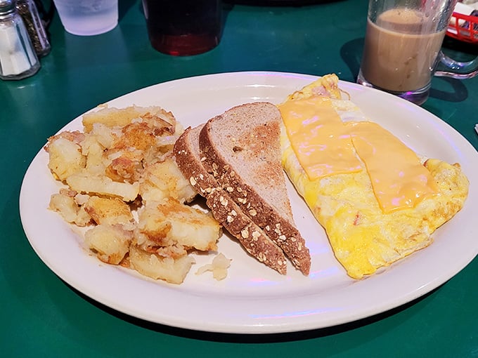 Breakfast doesn't get more honest than this – a fluffy omelet, crispy home fries, and toast that's ready to soak up last night's decisions.