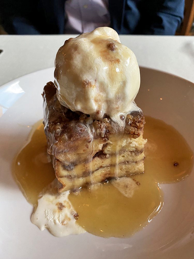 Not all heroes wear capes – some come as bread pudding topped with ice cream and swimming in bourbon sauce. This dessert deserves its own ZIP code.
