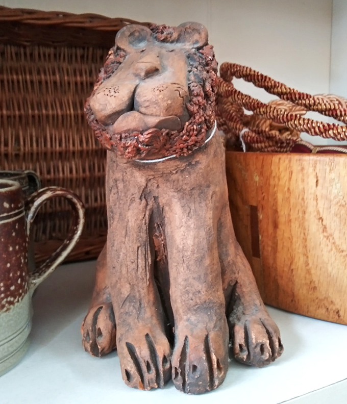This terracotta lion isn't just decor—he's the unofficial guardian of vintage treasures, judging your purchases with his eternally amused expression.