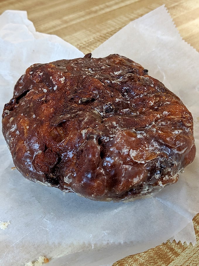 This apple fritter looks like it survived a delicious explosion of cinnamon, apples, and pure happiness.
