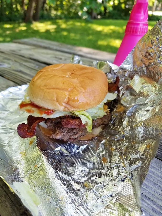 Behold the bacon cheeseburger in its natural habitat—where lettuce, tomato, and special sauce create the holy trinity of handheld happiness.