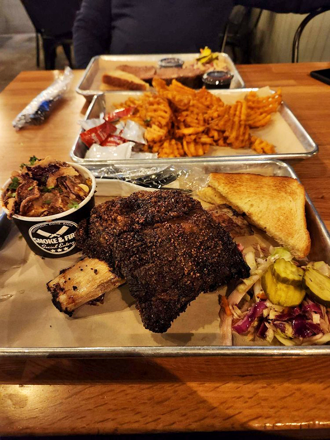 BBQ platter perfection: pepper-crusted ribs with a bark so beautiful it deserves its own Instagram account, alongside waffle fries and tangy slaw.