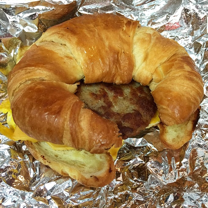 Breakfast engineering at its finest—a golden croissant embracing eggs, cheese and sausage. The morning commute's perfect companion.