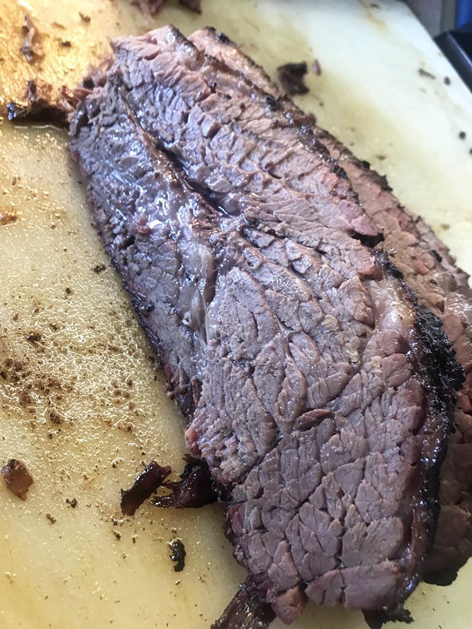 Brisket so tender it practically surrenders to your fork. That smoke ring isn't just for show – it's a flavor halo around meat heaven.