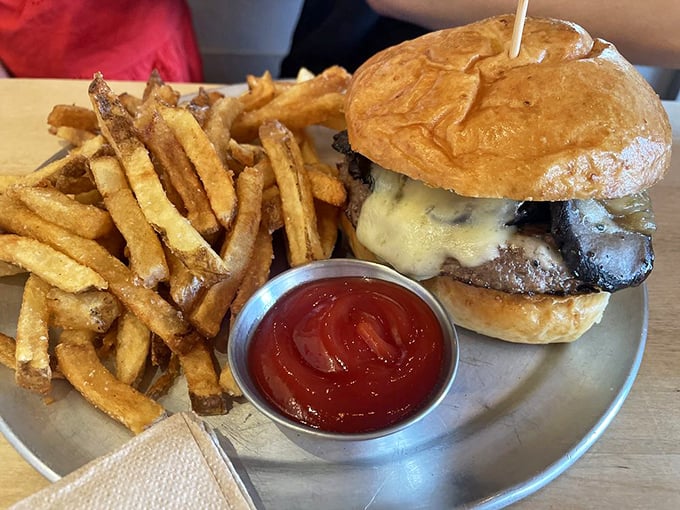 A perfect burger-to-bun ratio, melted cheese cascading down the sides, and hand-cut fries – this isn't just lunch, it's edible architecture.
