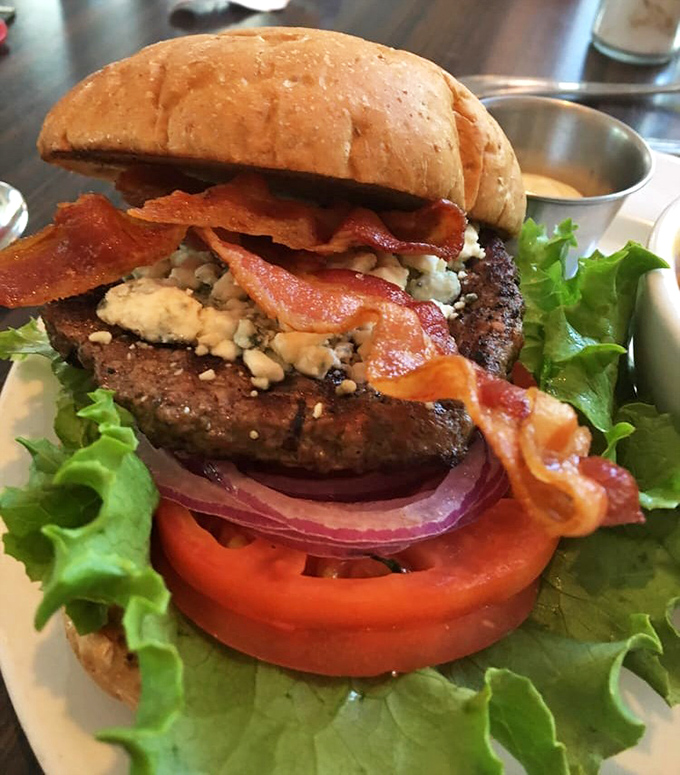 This isn't just a burger—it's a towering achievement of beef, blue cheese, and bacon that makes you want to plant a flag in it.