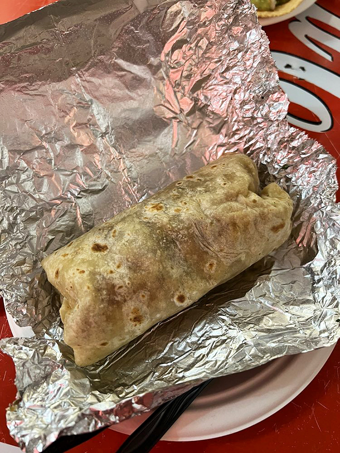 Wrapped in foil like a precious gift, this burrito contains multitudes—a universe of flavor waiting to be unwrapped and devoured.