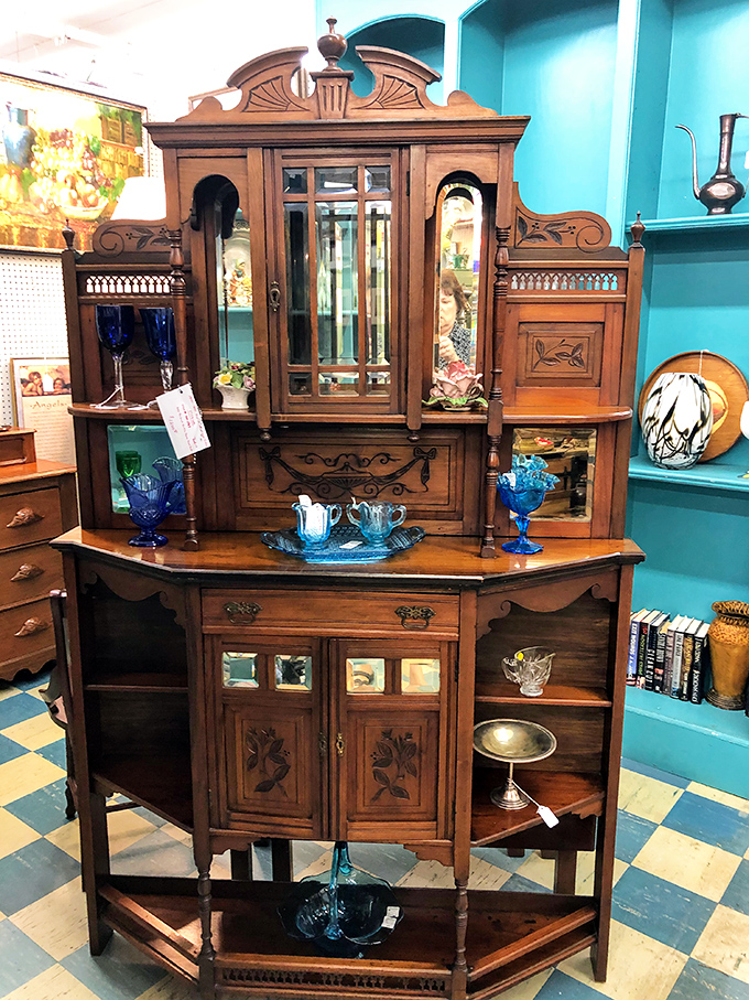 This Victorian-era cabinet wasn't just furniture—it was Facebook, family storage, and status symbol all rolled into one magnificent wooden showpiece.