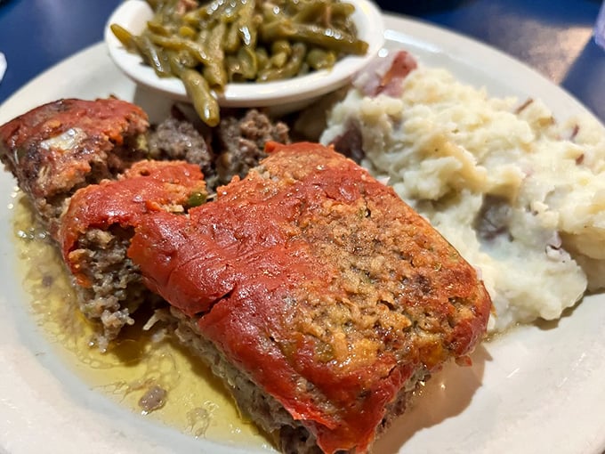 Meatloaf that would make your grandmother jealous, swimming in savory gravy alongside green beans and mashed potatoes. Comfort on a plate.
