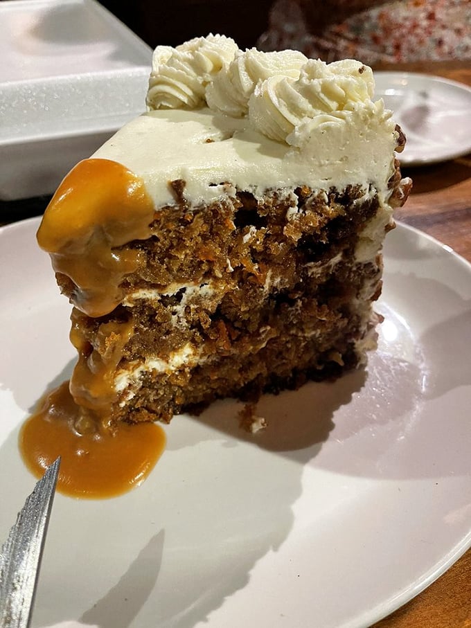 Behold the legendary carrot cake in all its glory—layers of spiced perfection drizzled with caramel that would make even the Easter Bunny abandon his diet.