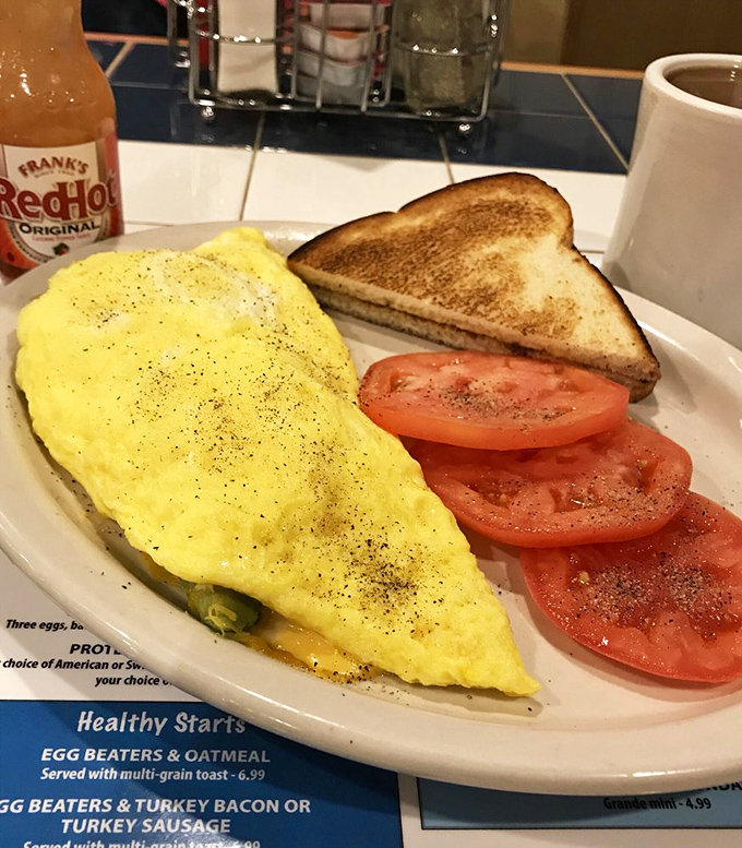 This omelet doesn't just contain cheese—it celebrates it, with fresh tomatoes providing that perfect acidic counterpoint to morning richness.