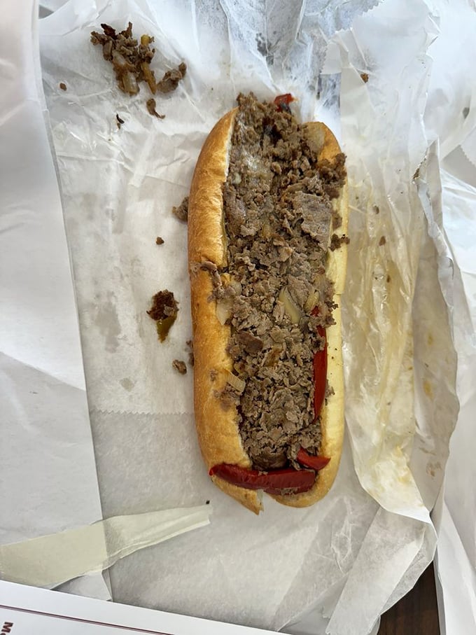 Behold the cheesesteak in its natural habitat – tender meat, melted cheese, and a roll that's both sturdy enough to support and soft enough to surrender.