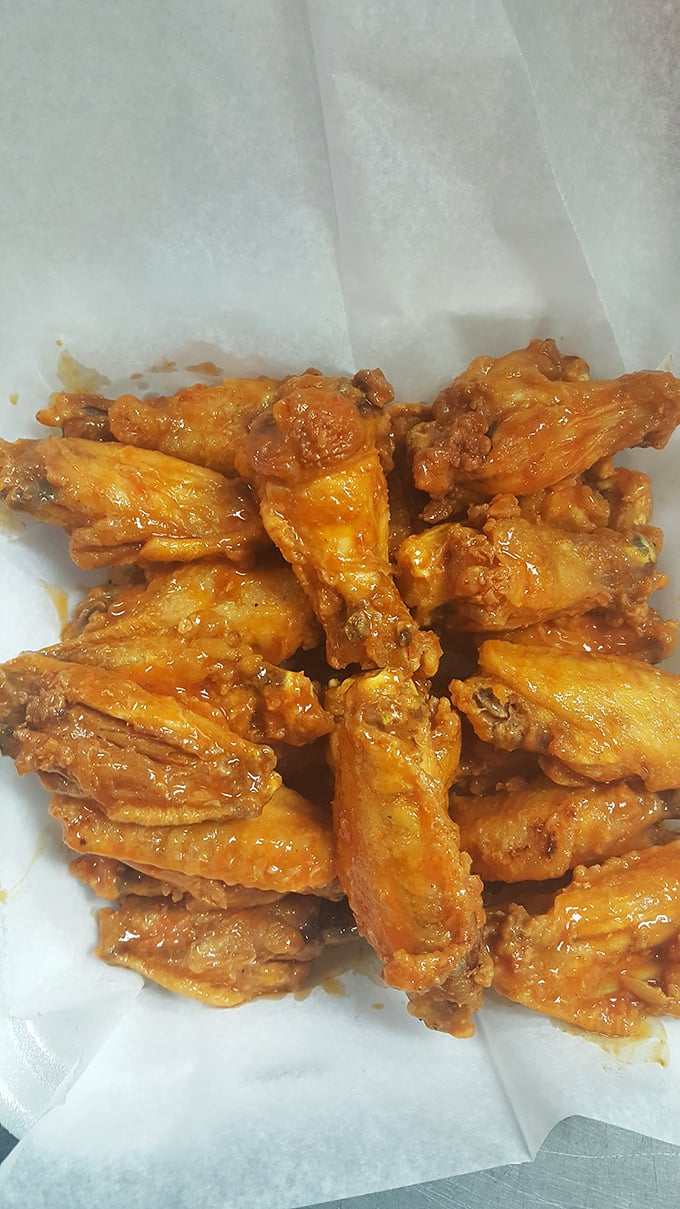 These wings aren't just cooked; they're transformed into crispy, saucy messengers of joy that make napkins necessary and diets optional.