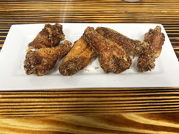 Dry-rubbed wings that make you question why anyone bothers with sauce. The kind of crispy exterior that makes that satisfying sound when you bite in.