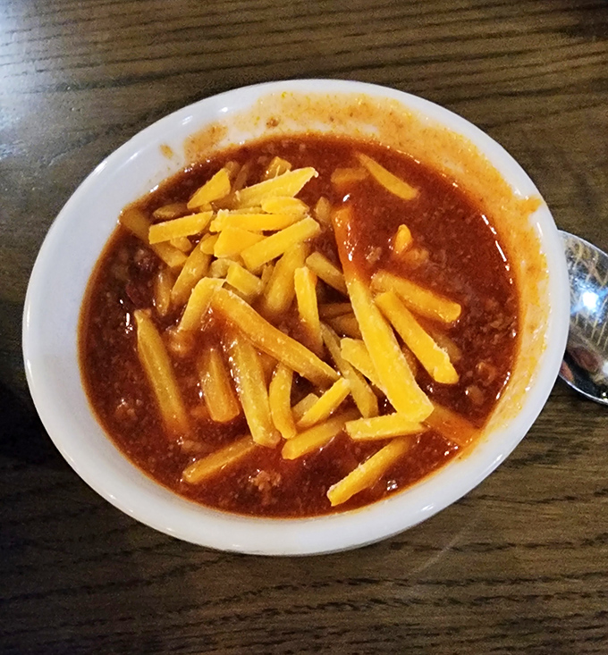 This isn't just chili—it's a hearty bowl of Midwest tradition topped with enough cheese to make Wisconsin nervous.