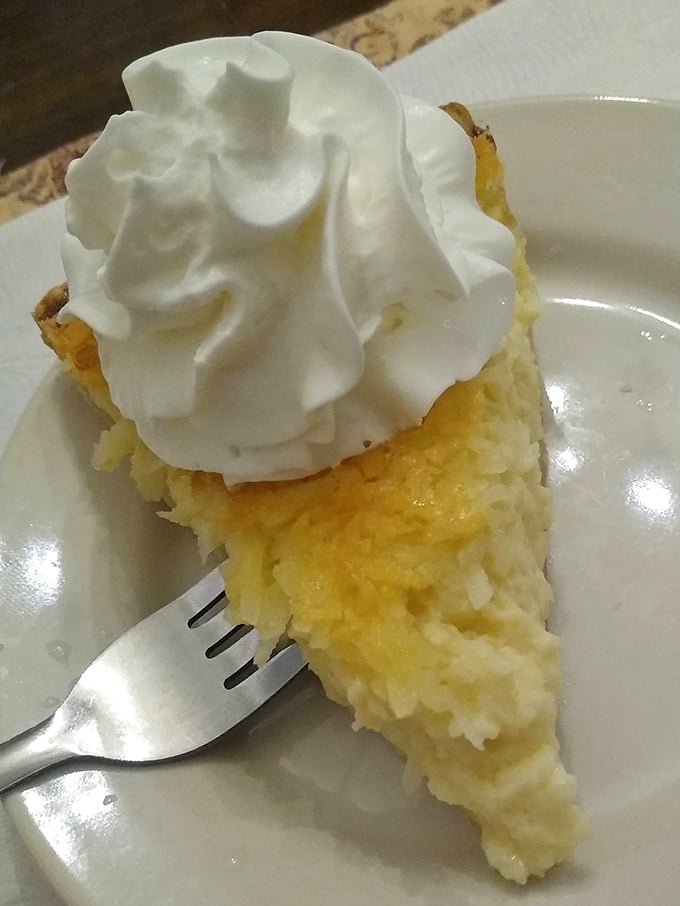 Coconut cream pie that deserves its own zip code. That cloud of whipped cream isn't garnish—it's the heavenly gateway to coconut paradise below.
