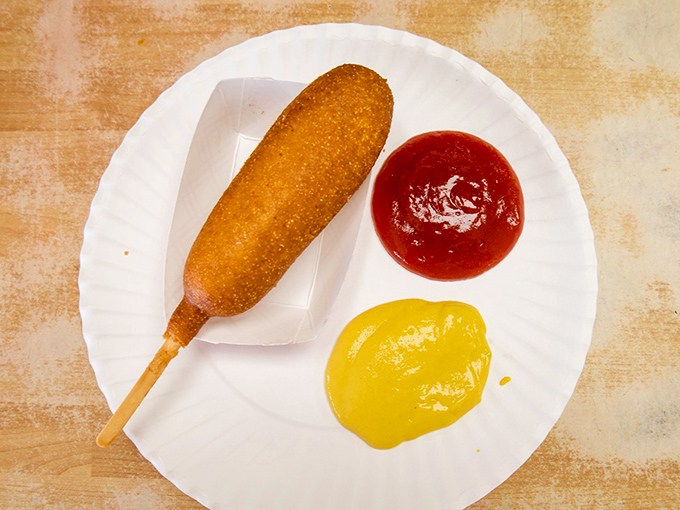 The humble corn dog – childhood nostalgia on a stick, golden-fried to perfection and waiting for that first satisfying crunch.