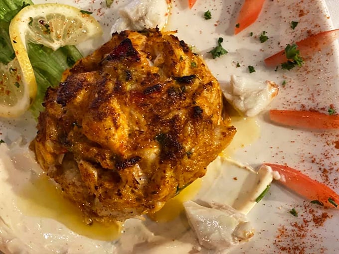 The legendary crab cake that launched a thousand road trips—golden-crusted perfection with barely enough binder to keep the sweet lumps together.