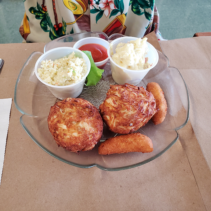 Golden crab cakes paired with creamy sides – this is comfort food that knows how to dress up properly.