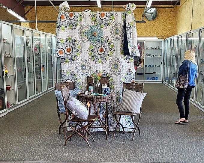 Handcrafted quilts and vintage textiles create a colorful backdrop for this inviting vignette. Mid-century design meets modern shopper in this carefully curated corner.