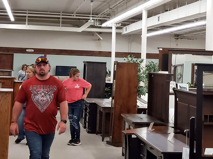 Treasure hunters in their natural habitat, navigating aisles of history. The serious expressions say it all – antiquing is serious business!
