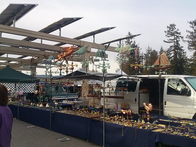 Whimsical weathervanes and garden art create a colorful skyline above the vendor tables. Your garden called—it's feeling a bit underdressed.