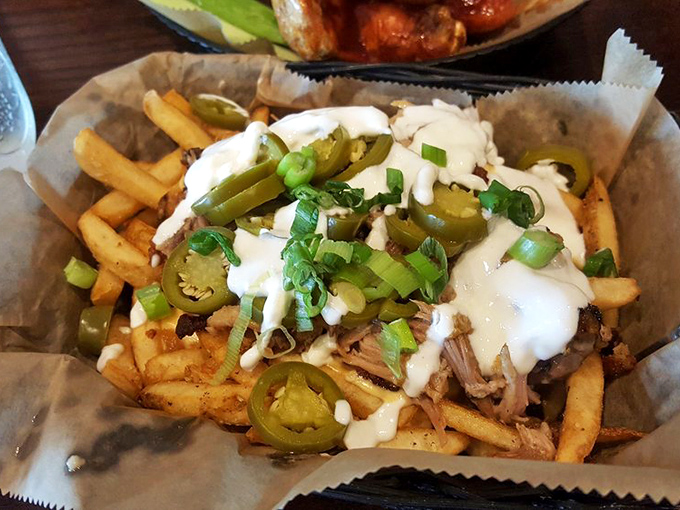 Loaded fries that don't just cross the line into decadence—they sprint past it, waving jalapeños and melted cheese like victory flags.