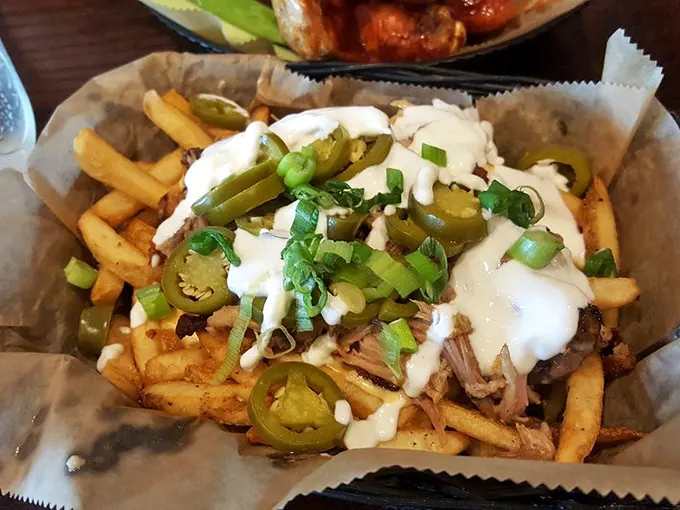 Loaded fries that don't just cross the line into decadence—they sprint past it, waving jalapeños and melted cheese like victory flags.