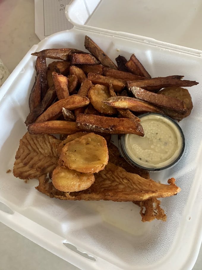 Fries that deserve their own zip code – golden, crispy, and served with a dipping sauce that makes you wonder why you ever bothered with ketchup.