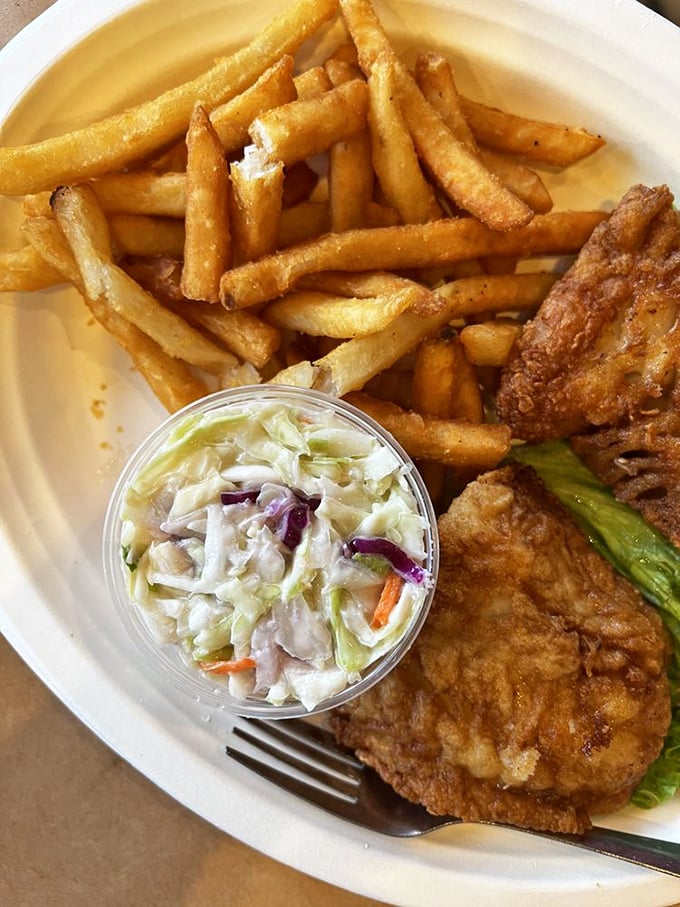 The fish sandwich arrives with golden fries and creamy slaw – a trio that's been making diners happy since before Instagram made food famous.