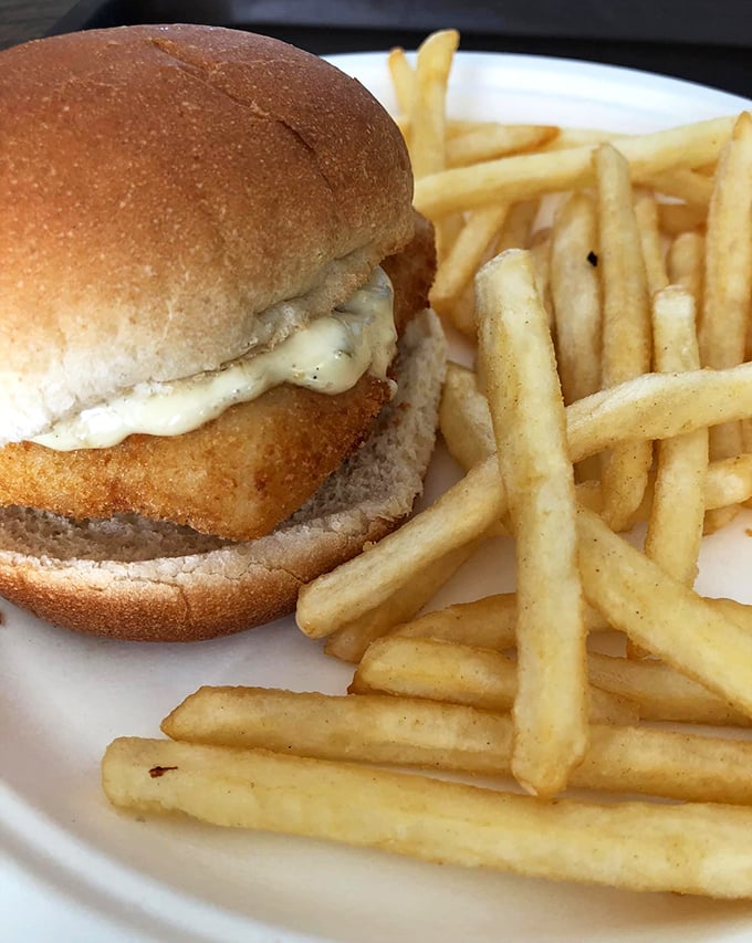 The famous fish sandwich in all its glory, accompanied by perfectly crisp fries. This is what seafood dreams are made of—simple, honest, and utterly delicious.