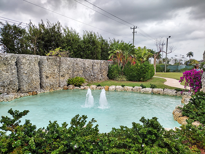 The serene fountain offers a tropical oasis amid the stone structures, proving that even a heartbroken engineer appreciated a little aesthetic balance.