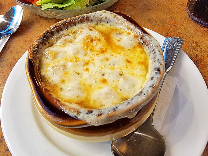 Behold the French onion soup that's causing all the fuss – bubbling cheese perfection in every spoonful.