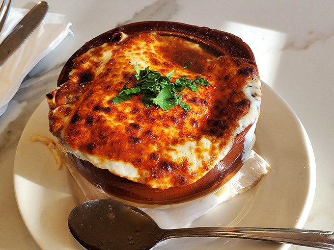 This isn't just French onion soup – it's a bubbling masterpiece that redefines comfort in a crock.