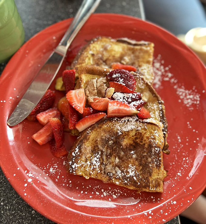 French toast that could make a pancake jealous. Those fresh strawberries aren't just garnish—they're the supporting actors in this breakfast drama.