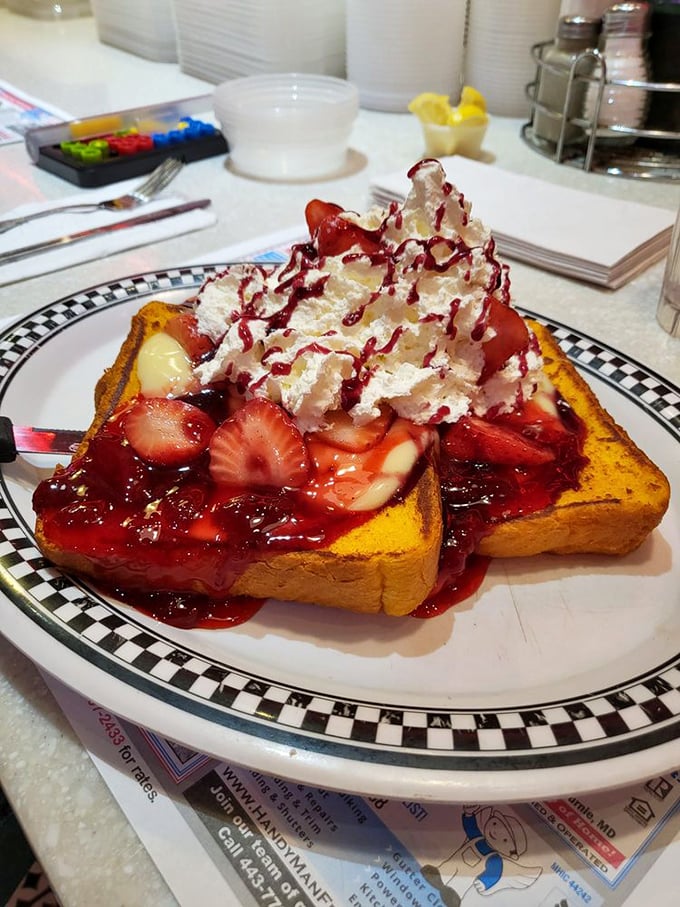 The strawberry French toast doesn't just feed you – it hugs your soul. That mountain of whipped cream and berry sauce is basically therapy on a plate.
