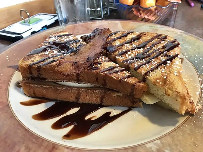French toast that's dressed for success with chocolate drizzle. Like a breakfast dessert that somehow feels justified before noon.