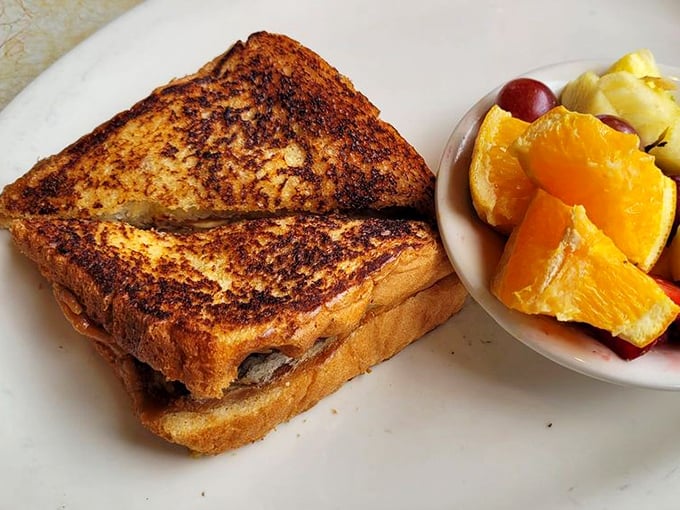 This isn't just grilled cheese—it's a golden-brown masterpiece with the perfect fruit sidekick. Comfort food that graduated with honors.