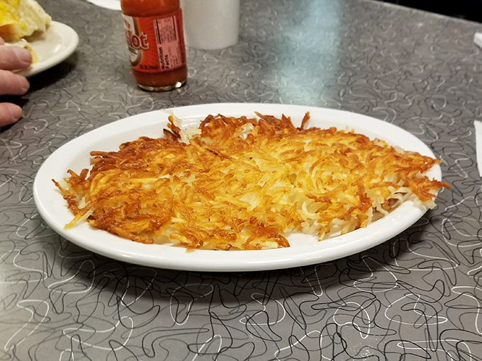 Hash browns so perfectly golden and crispy, they deserve their own zip code. Breakfast nirvana achieved on a humble white plate.