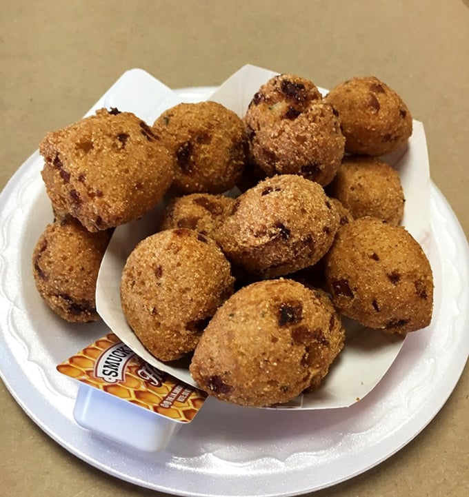 Golden-brown hush puppies that could make a Southern grandmother weep with joy – crispy outside, tender inside, perfect for sopping up crab juices.