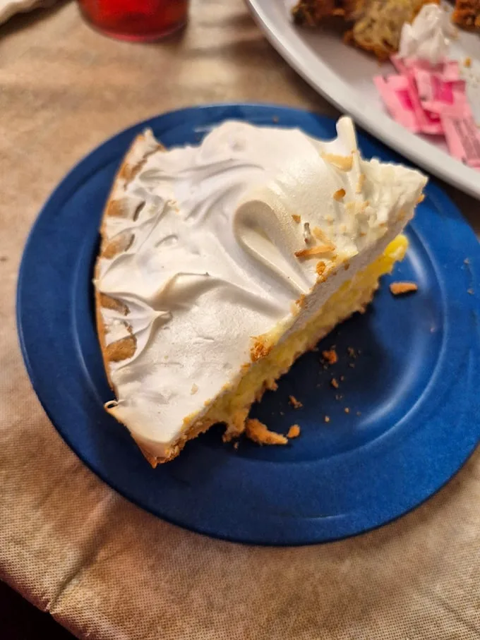 Lemon meringue pie with clouds of meringue so perfect they deserve their own weather system. This isn't dessert—it's edible happiness.