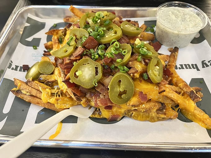 Loaded fries that don't mess around—crispy potatoes crowned with melted cheese, bacon, jalapeños, and a side of pure joy.