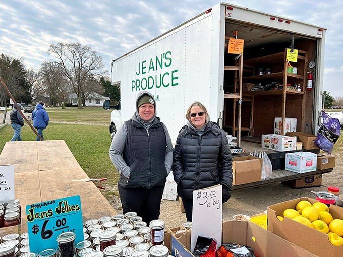 Farm-fresh finds! Jean's Produce brings local bounty to market shoppers, with homemade jams and bright yellow lemons brightening a cloudy Michigan morning. 