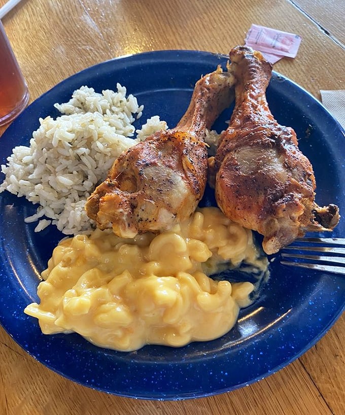 Fried chicken legs nestled against creamy mac and cheese—a plate that whispers "nap time" even as you're taking your first bite.