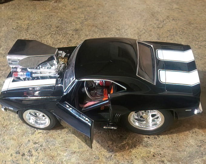 The collectibles section: where one person's decluttered shelf becomes another's prized display. This miniature muscle car represents thrifting's greatest joy—the unexpected find.