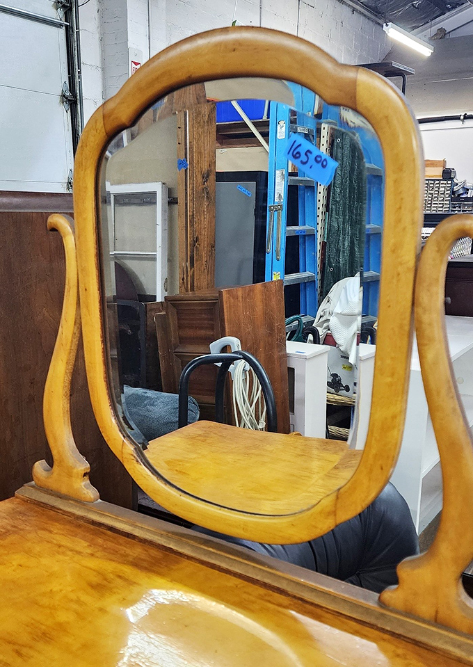 This isn't just a mirror—it's a time portal to when furniture was built with character. Reflect on that while admiring its curved wooden frame.