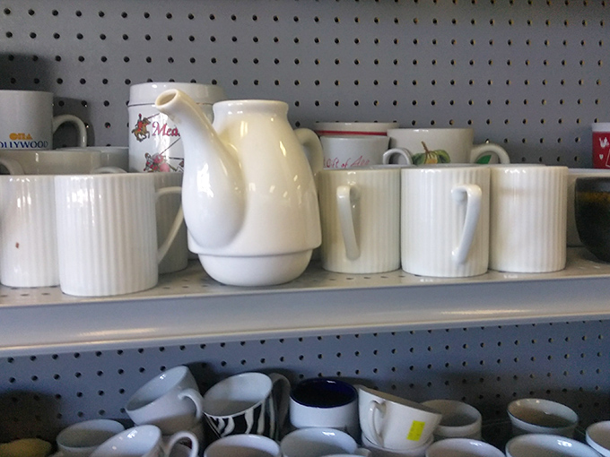 White ceramic teapots and mugs stand at attention, ready to serve their next family's morning rituals or afternoon tea parties.