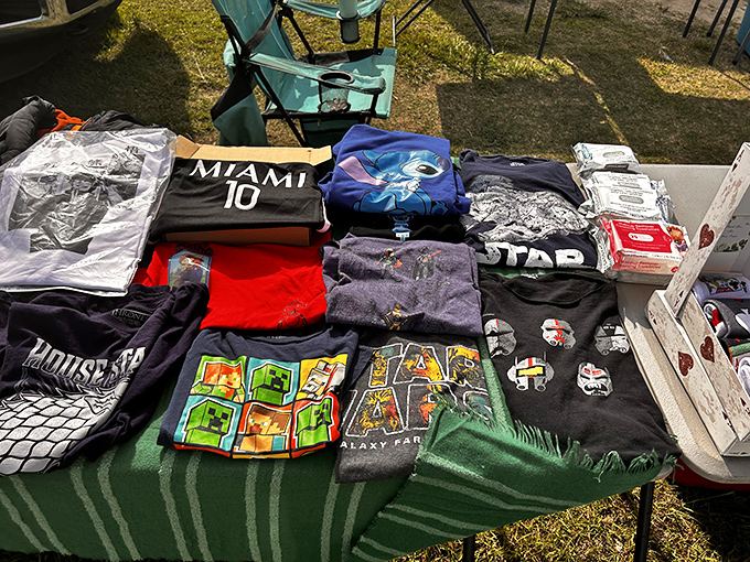 The unofficial uniform of flea market fashion—graphic tees displaying everything from Miami sports allegiance to Star Wars fandom.